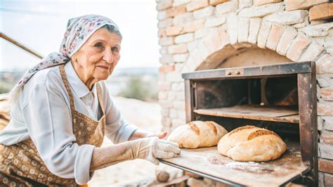 Premium Photo Elderly Woman Baking Bread In Traditional Oven