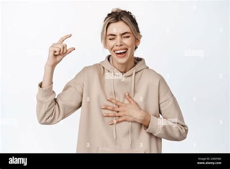 Image Of Young Woman Pinching Fingers Holding Something Small Or Tiny
