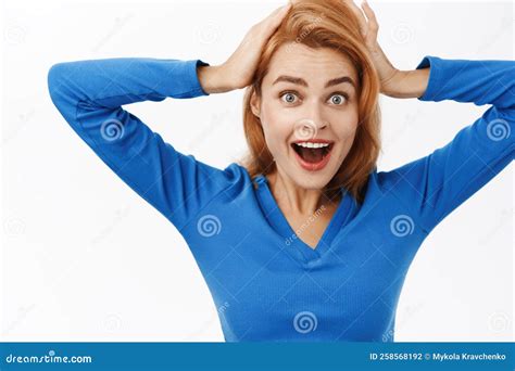 Close Up Portrait Of Woman Looking Surprise Holds Hands On Head And