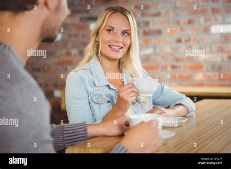 Smiling Blonde Having Coffee With Friend Stock Photo Alamy