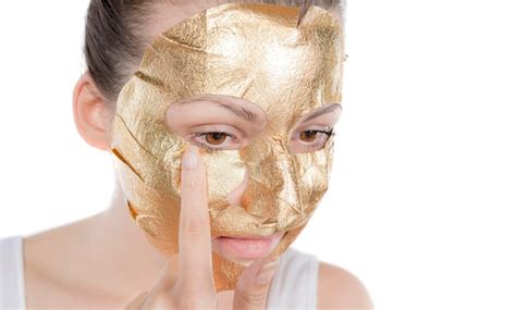 Premium Photo Portrait Of Sexy Healthy Girl Removing Peeling Cosmetic Gold Mask From