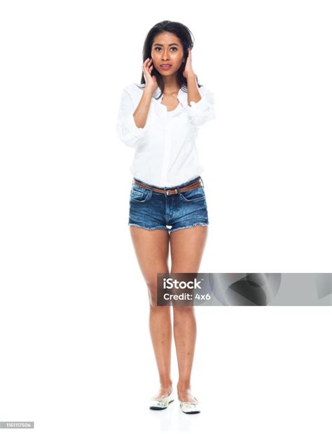 Beautiful Latino Woman Wearing White Shirt And Short Shorts Worried