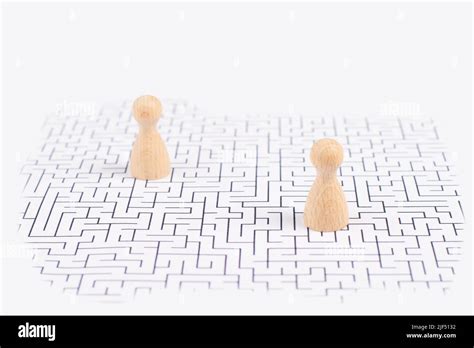 men stand in the middle of a labyrinth searching for a solution to exit finding a strategy
