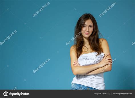 Beautiful Cheerful Teen Girl Jean Shorts White Top Blue Background