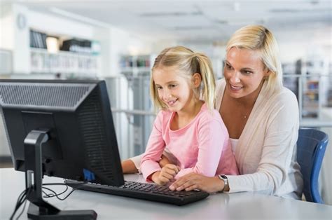 Mother And Girl Using Computer Premium Photo