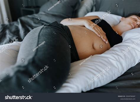 Pregnant Woman Sleeping On The Bed With A Pillow Over 1920 Royalty