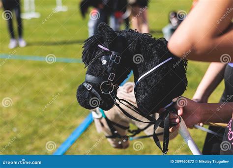 Hobby Horsing Competition On A Green Grass Hobby Horse Riders Jumping