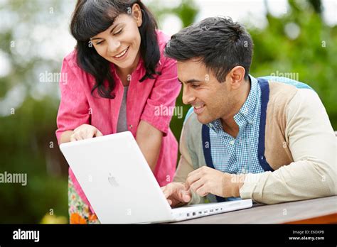 Couple Browsing Web Using Laptop Stock Photo Alamy