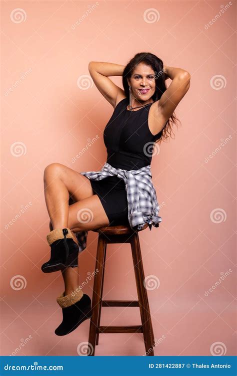 Mature Brunette Woman Wearing Black Outfit And Checkered Blouse Of