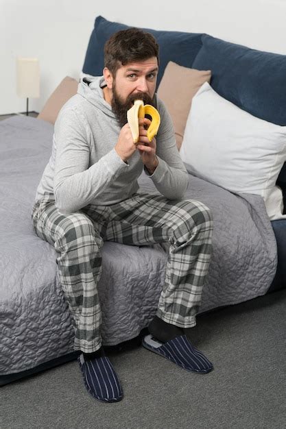 Premium Photo Morning Vibes At Home Bearded Man Hipster Eat Banana In