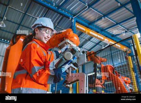 Woman Smart Engineer Worker Programming Control Robot Assembly Arm In