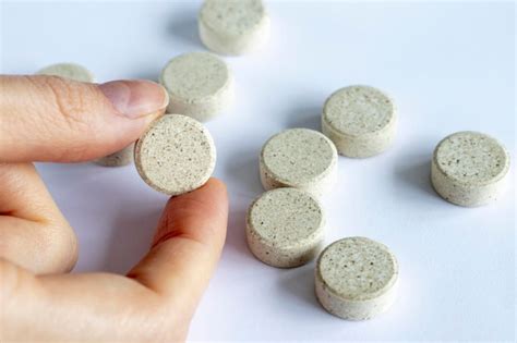 Premium Photo Picture Of Dgl Chewable Licorice Root Extract Tablets In A Womans Hand Against