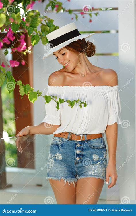 Tanned Beautiful And Girl In A White Hat Smiles In Summer Stock Image