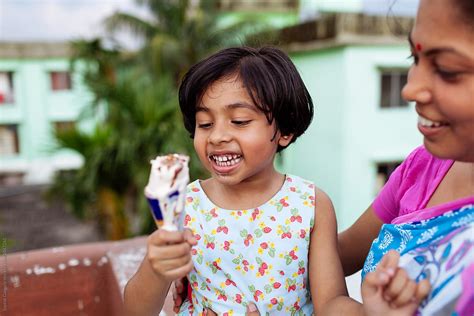 Mother And Daughter Enjoying An Ice Cream On A Hot Day By Stocksy Contributor Saptak Ganguly