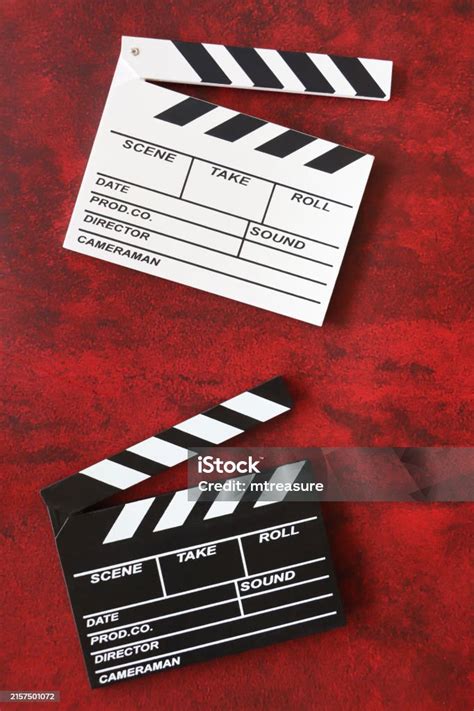 두 개의 필름 클래퍼 보드 하나는 흰색이고 다른 하나는 검은색 필름 슬레이트와 열린 힌지 클래퍼 스틱 얼룩덜룩한 빨간색 배경