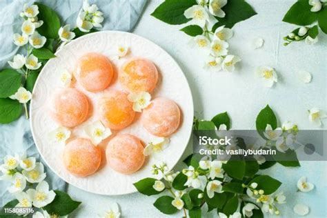 쌀 반죽에 여러 가지 빛깔의 일본식 아이스크림 떡과 콘크리트 파란색 배경에 자스민 꽃 화이트 플레이트에 일본 전통 디저트 맨 위 보기 플랫 레이 0명에 대한 스톡 사진 및