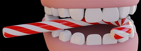 흰색과 빨간색 줄무늬 사탕 막대 사탕은 흰색 배경에 격리 된 치아 사이에 붙어 있습니다 치과 의사 및 치과 건강 개념 3차원 인쇄에 대한 스톡 사진 및 기타 이미지 Istock