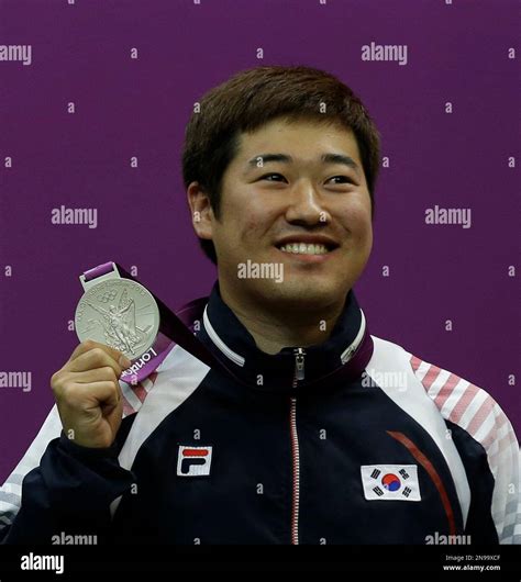 South Koreas Kim Jonghyun Holds Up His Silver Medal During The