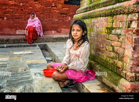 Young Girl Begging For Alms At Pashupatinath Temple Complex In