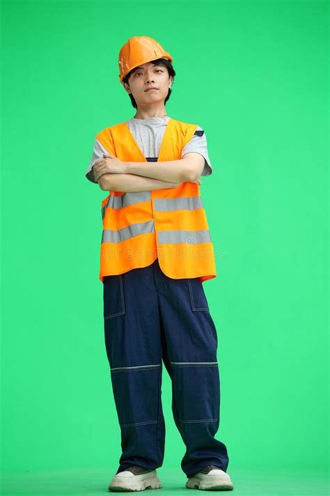 The Construction Guy On A Green Background In Full Height Crossed His Arms Stock Image