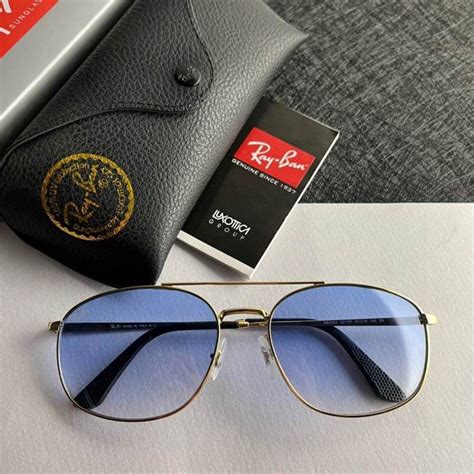 Ray Ban Rb3654 Rectangular Sunglasses Gold Frame Clear Blue Lenses 1