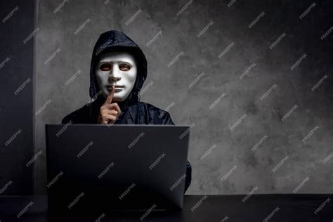 Premium Photo Portrait Of Computer Hacker With Finger On Lips Sitting