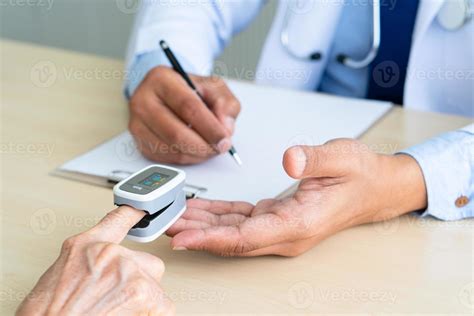 Doctor Measuring Oxygen Saturation Of Patient Stock Photo At Vecteezy