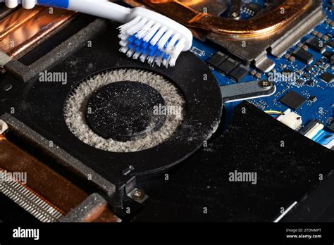 Dirty Laptop Computer Fan Full Of Dust And Needs Cleaning Using A Toothbrush Stock Photo Alamy
