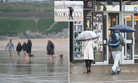 Beach Goers In Cornwall Wrap Up As Showers Spreads Across Much Of The