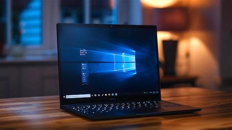 Premium Photo Laptop On A Wooden Table The Screen Is On And