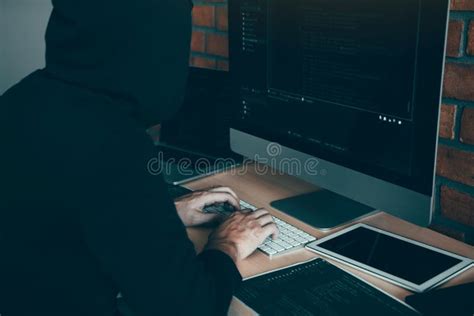Hacker In The Hood Working With Computer With Hacking Breaking Into