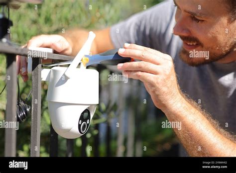 Happy Man Installing Wifi Security Camera In A House Garden Stock Photo Alamy