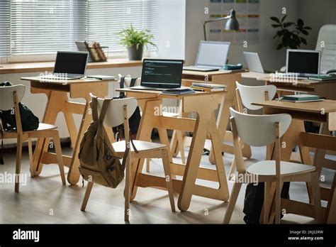 Horizontal Image Of Empty Class With Desks And Computers On Them For It