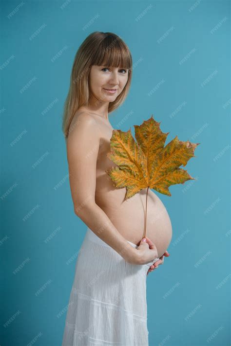 Portrait Of Smiling Pregnant Woman Indoor In Blue Wall Healthy
