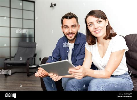 Positive Couple Using Wifi At Home Stock Photo Alamy