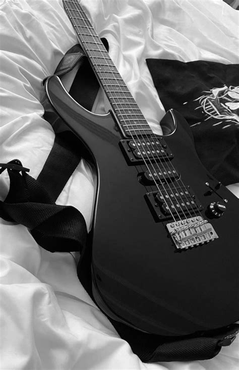 Black Electric Guitar On Bed