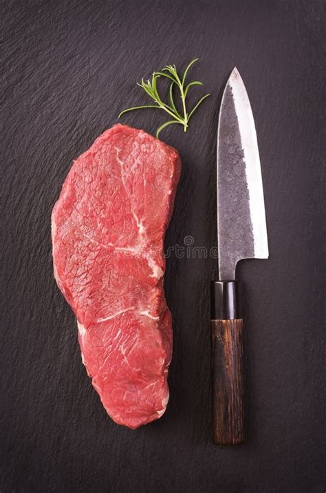 Raw Dry Aged Angus Roast Beef Steak On A Design Board With A Japanese