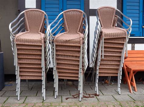Three Stacks Of Chairs Standing Side By Side A Stack Of Chairs Tied