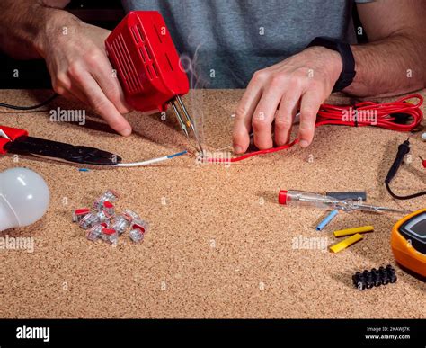 Soldering Connecting Wires With Tin And Soldering Iron Workshop In The Background Electrical