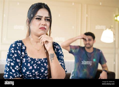 Irritated Wife While Talking With Angry Husband At Home On Couch