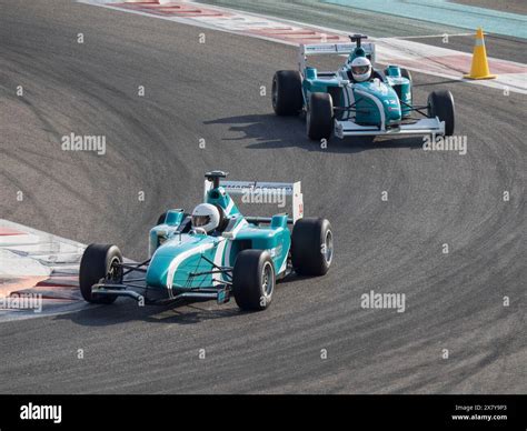 Two Racing Cars Driving Close Together At High Speed Round A Curve Two Racing Cars Driving Close Together At High Speed Round A Curve