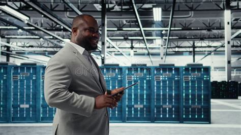 Cheerful Server Room Engineer Troubleshooting Backend Operations Using