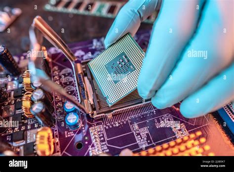 Engineer Repairman Holding Hands In Black Gloves Chip Processor CPU To Insert Into The Socket