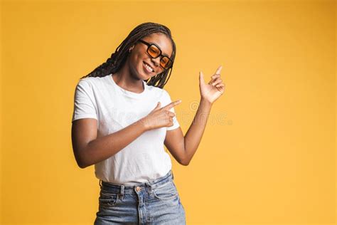 Excited Enthusiastic Woman In Sunglasses Dancing Isolated On Yellow