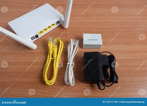 Complete Set Modem Router Wifi Wireless Lan And Adsl Cable Splitter And Adapter On Wooden