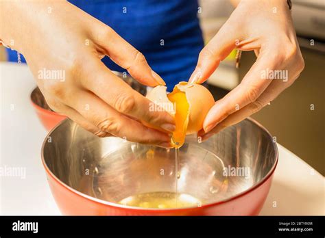 Woman S Hands Separating Egg Yolk From Whites Stock Photo Alamy