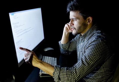 premium photo software developer computer at dark home office startup and hard working concept