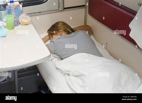 The Girl In A Train Sleeping On His Stomach With His Hands Behind His