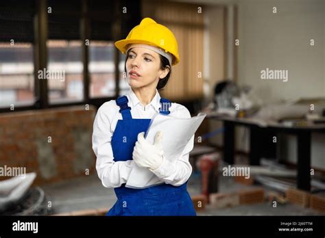 Forewoman Making Task List While Supervising Building Under