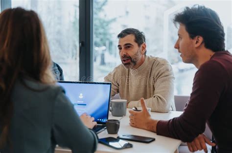 Colleagues Collaborating And Sharing Ideas In A Positive Atmosphere Stock Image Image Of